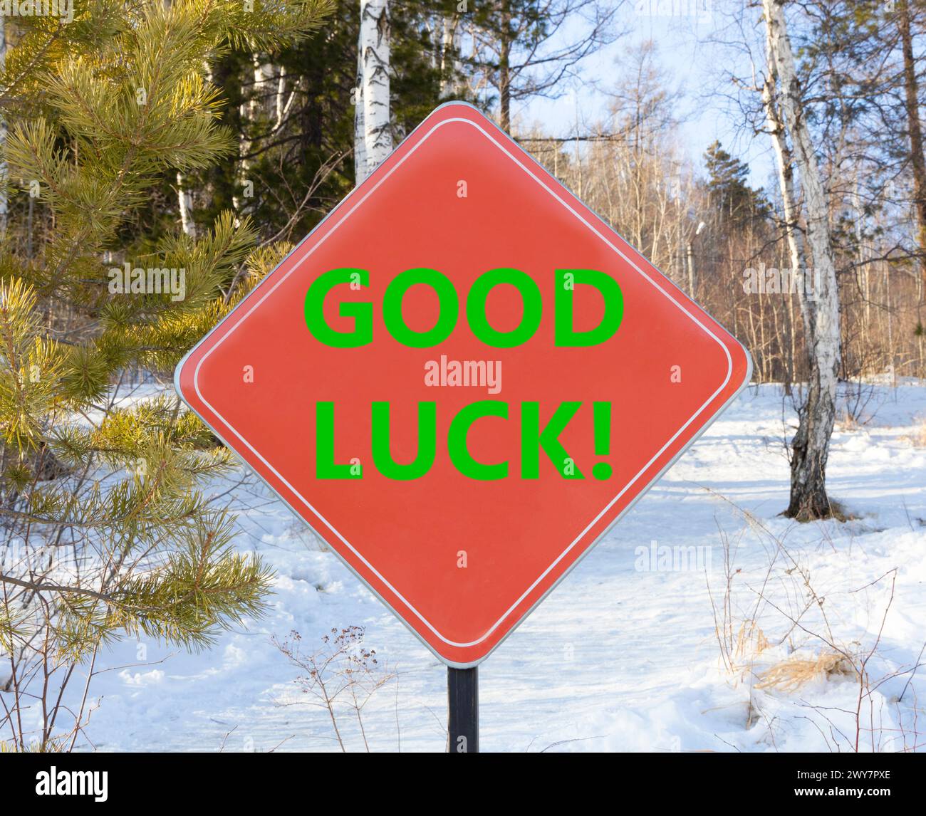 Good luck symbol. Concept words Good luck on beautiful red road sign. Beautiful forest snow blue ...