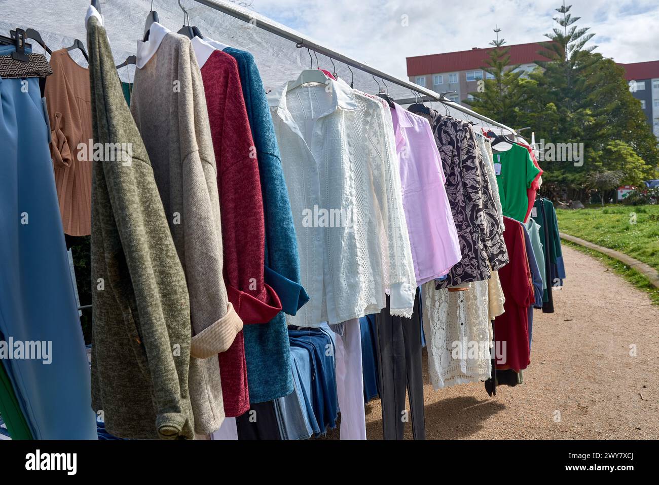 Clothes hanging on the hangers of a stall at the Coia urban market in ...