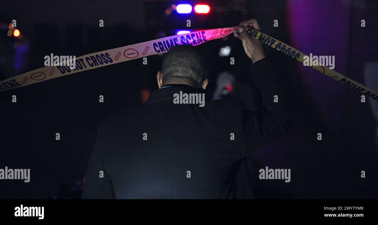 Police officer, man and yellow tape for crime scene, investigation or ...