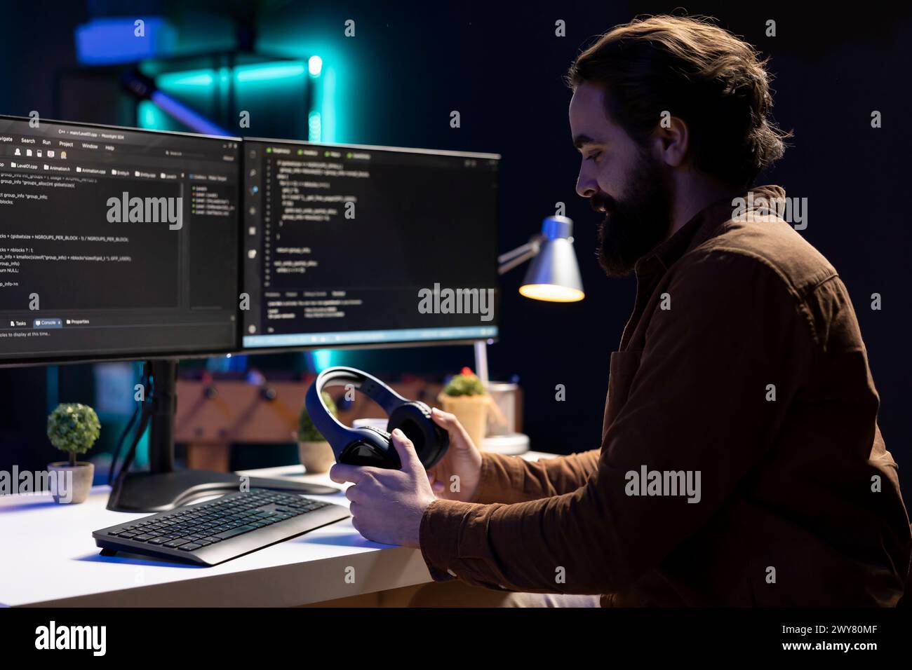 Programmer putting headphones on while implementing security measures ... Programmer putting headphones on while implementing security measures ...
