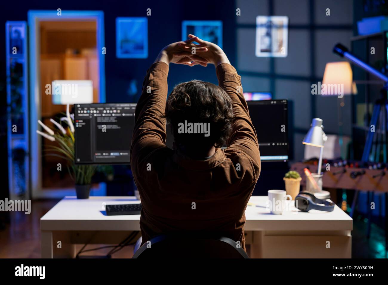 Programmer stretching body limbs after securing company servers from ...