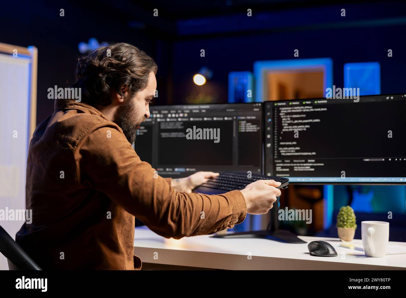 Angry man raging while doing software quality assurance, feeling mad after seeing errors in ...