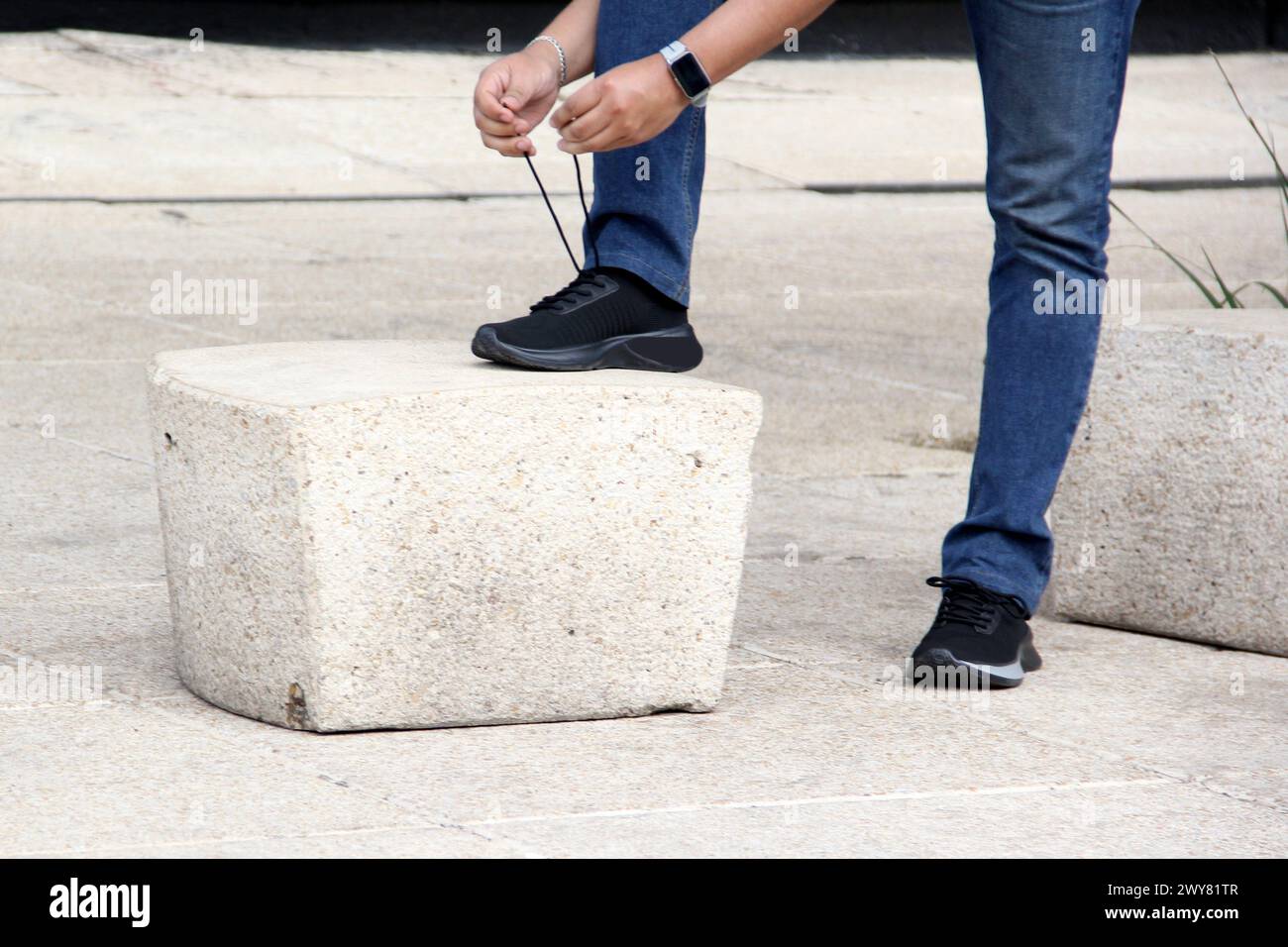 Latin adult man wears black tennis shoes that serve to protect the foot ...