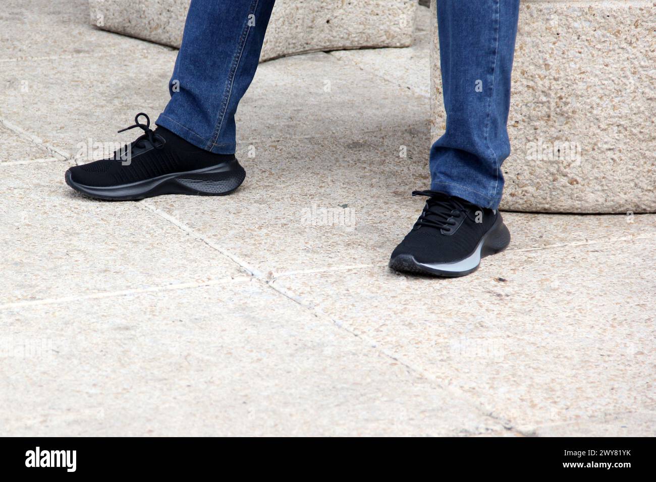 Latin adult man wears black tennis shoes that serve to protect the foot ...