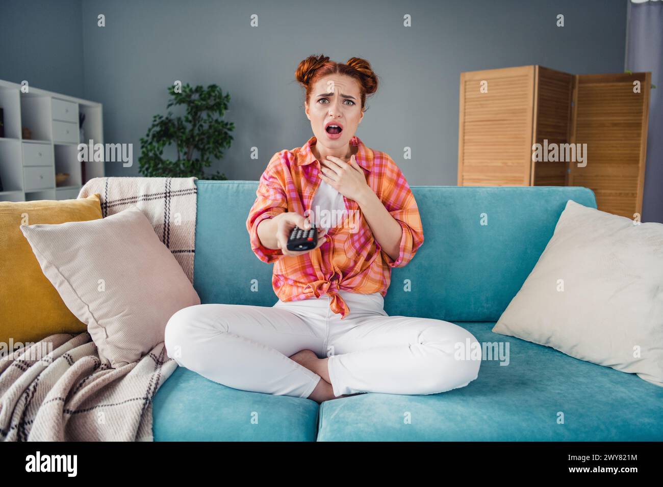 Full body photo of impressed unsatisfied lady sitting couch hold remote ...