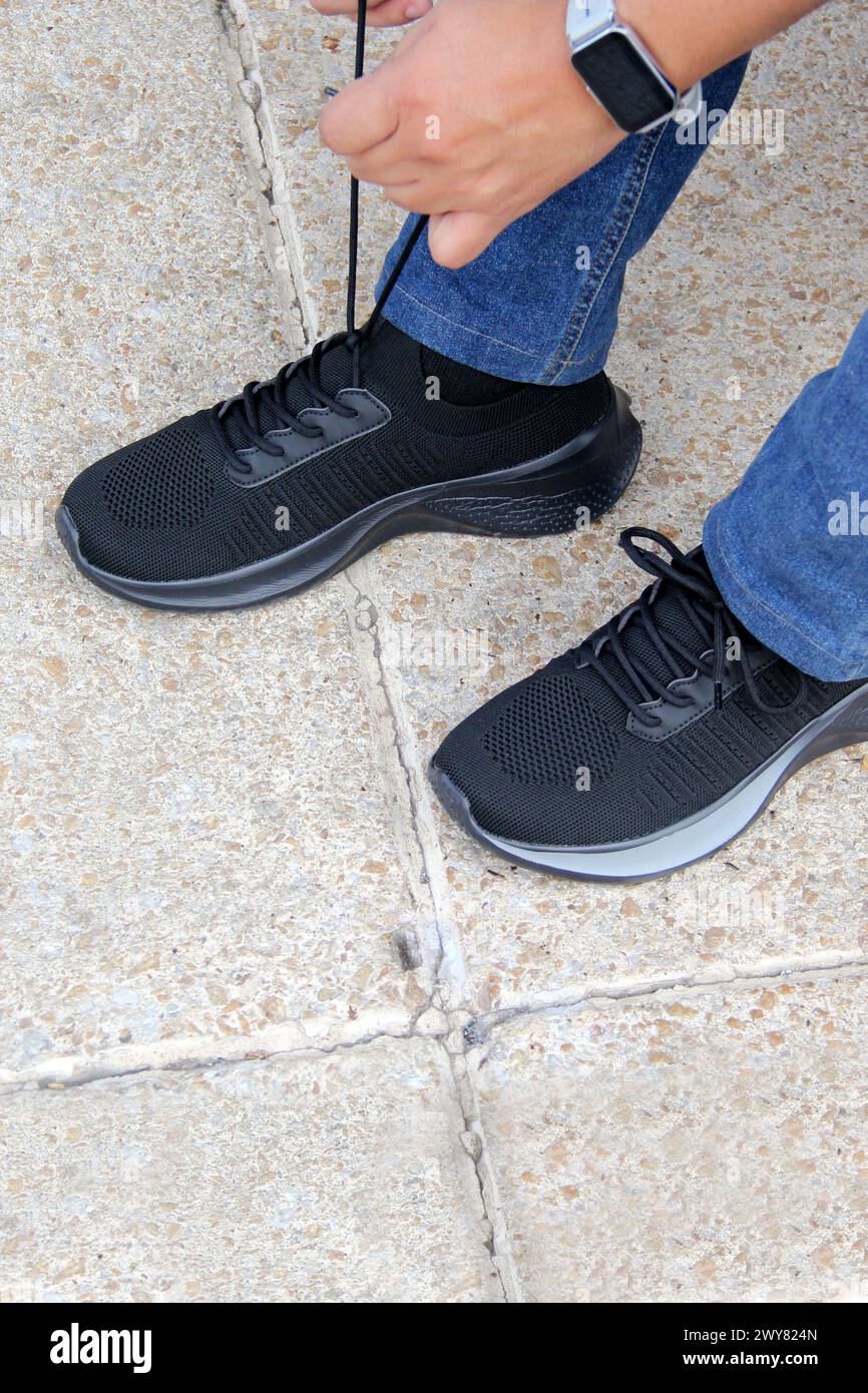 Latin adult man wears black tennis shoes that serve to protect the foot ...