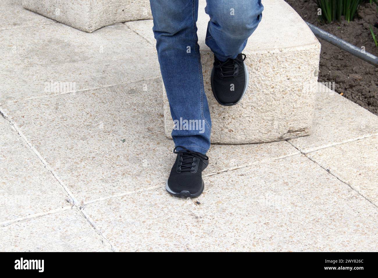 Latin adult man wears black tennis shoes that serve to protect the foot ...