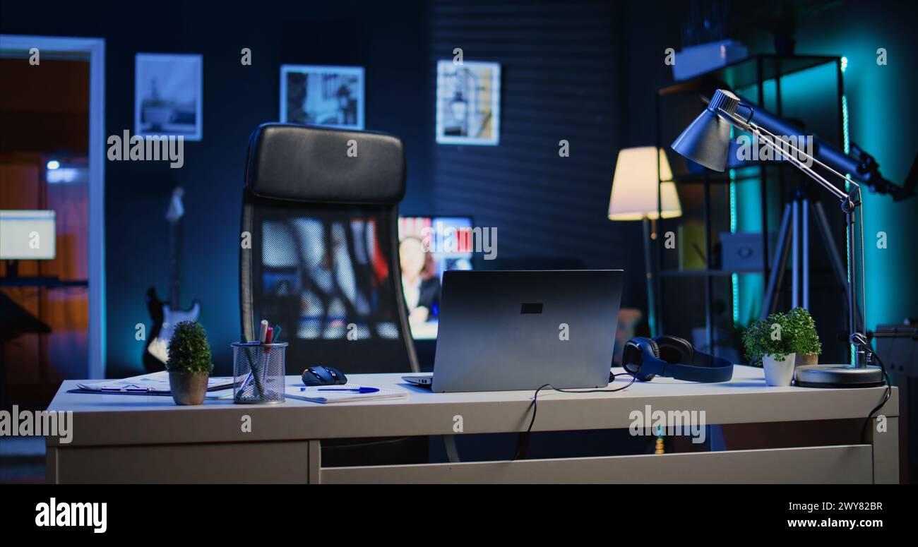 Focus on office desk in front of smart TV in blurry background ...