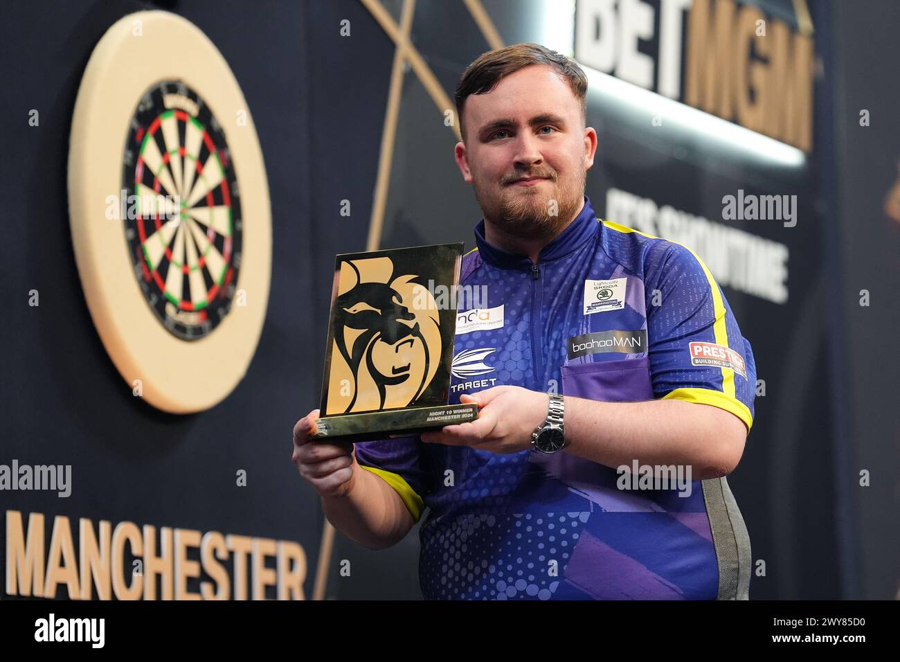 Luke Littler with the trophy after winning night ten of the 2024 BetMGM ...