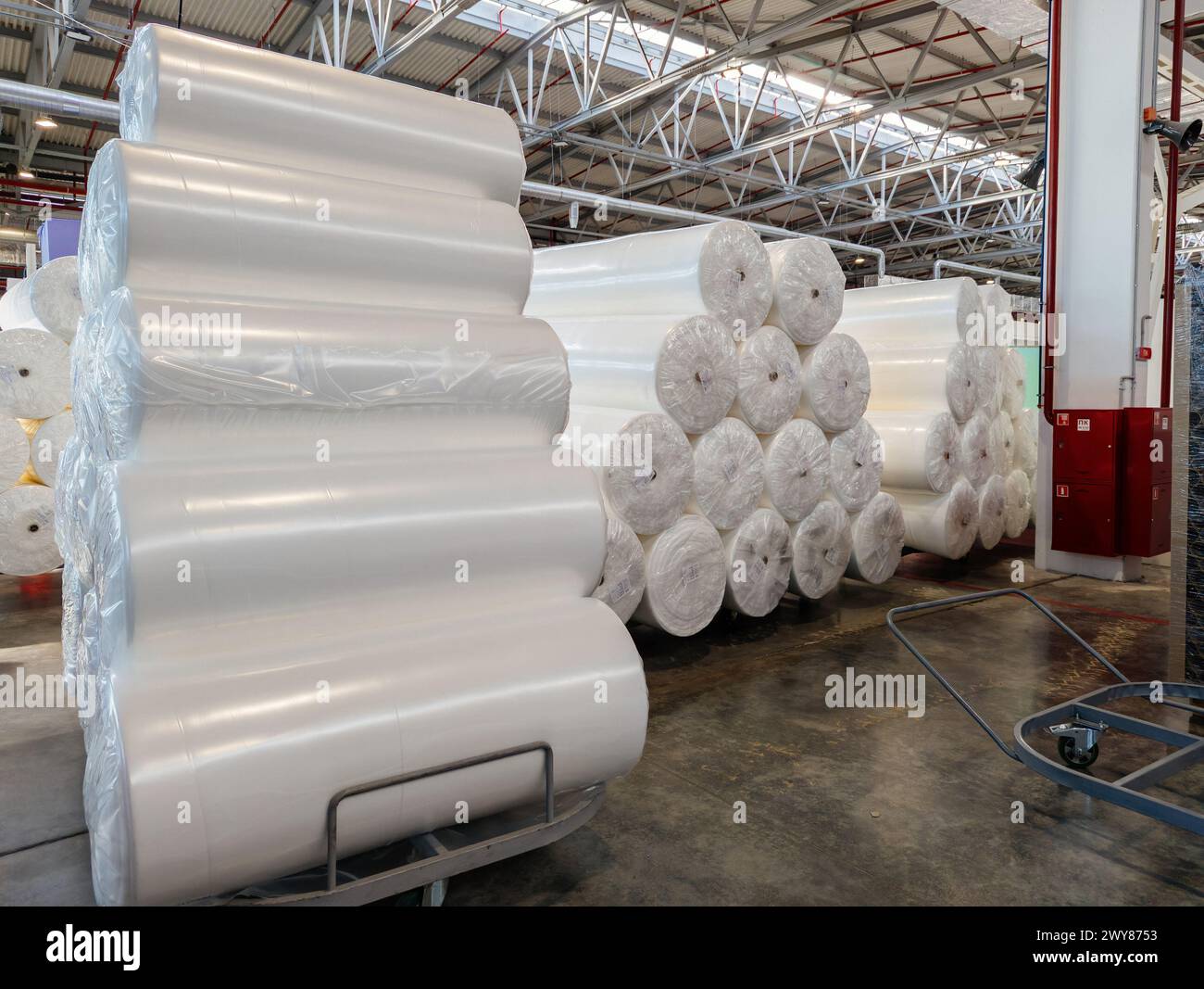 Packs of rolled foam rubber in warehouse Stock Photo - Alamy