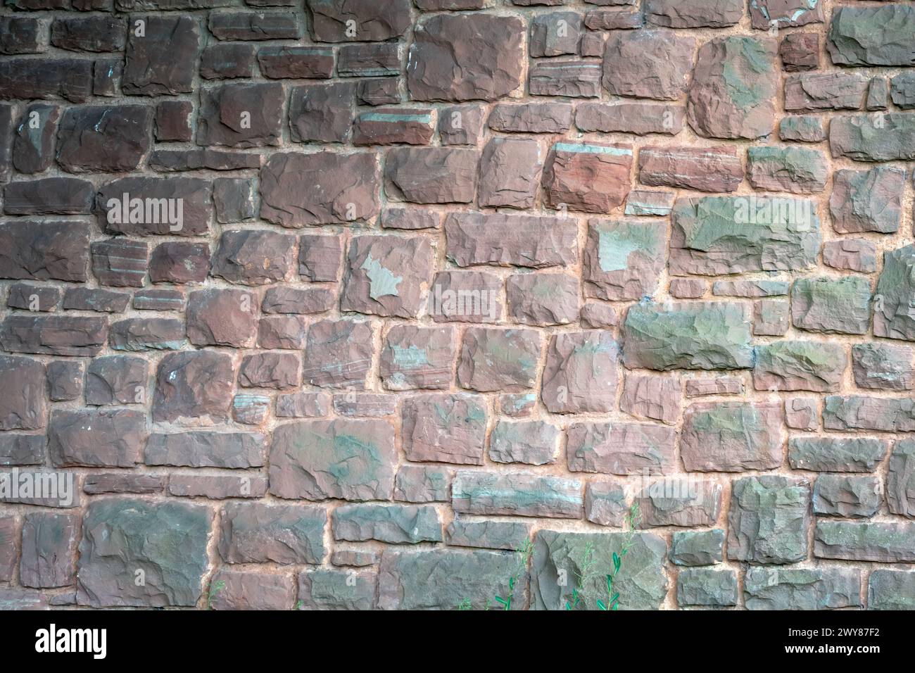 Reddish stone wall, can be used as a background Stock Photo - Alamy
