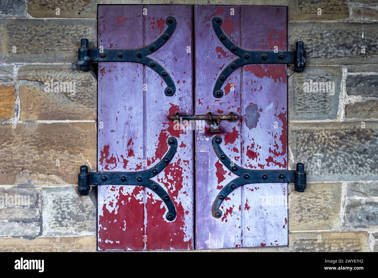 Wooden shutters with peeling paint and iron work Stock Photo - Alamy