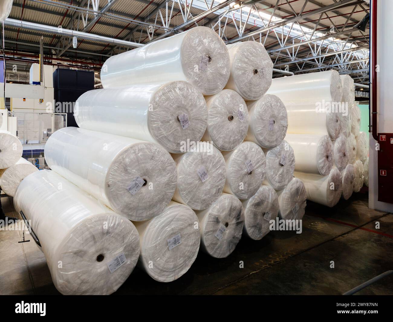 Packs of rolled foam rubber in warehouse Stock Photo - Alamy