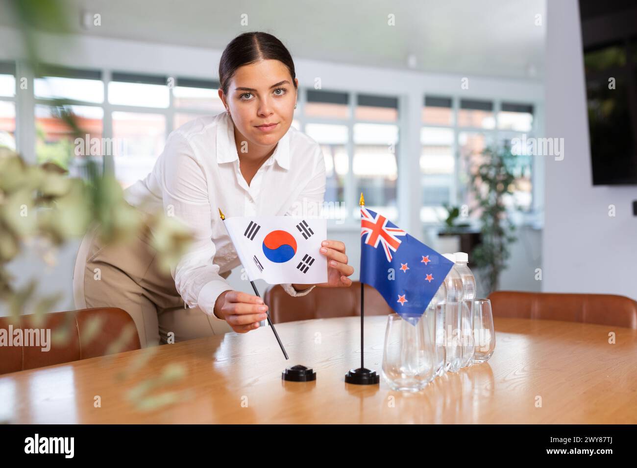 Businesswoman arranging the flags of South Korea and Australia for ...