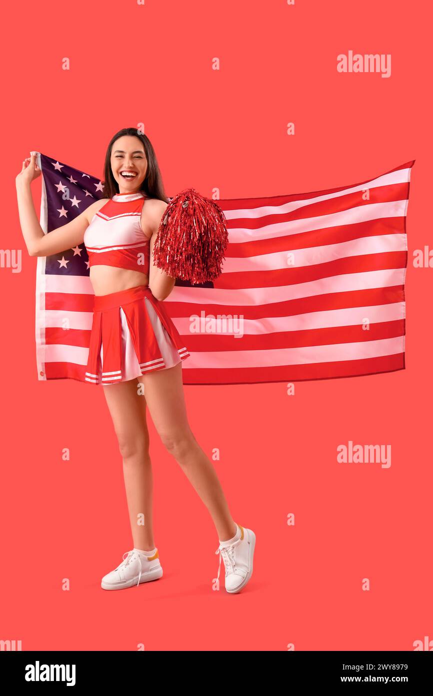 Female cheerleader with USA flag on red background Stock Photo - Alamy