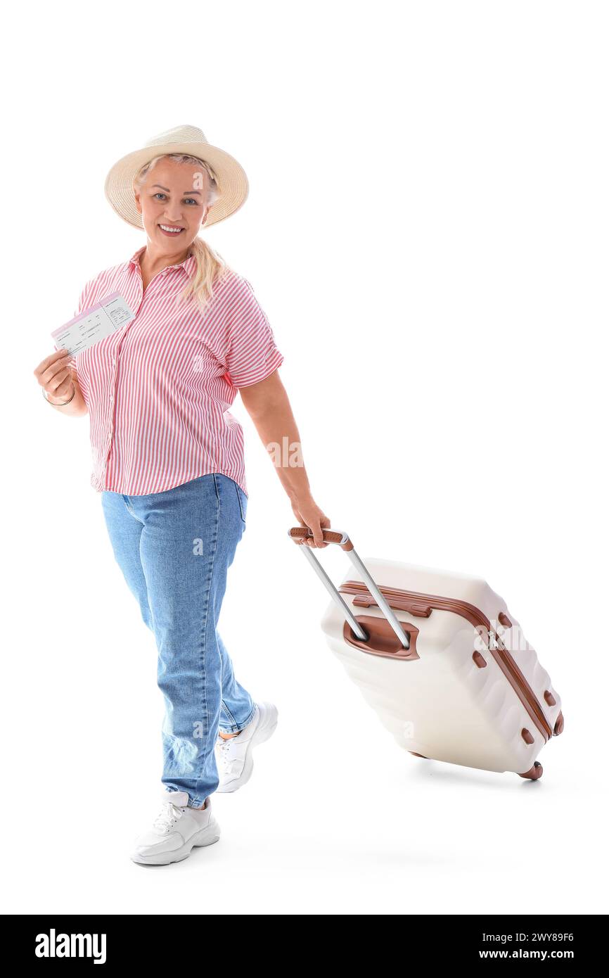 Senior woman with suitcase and boarding pass isolated on white ...