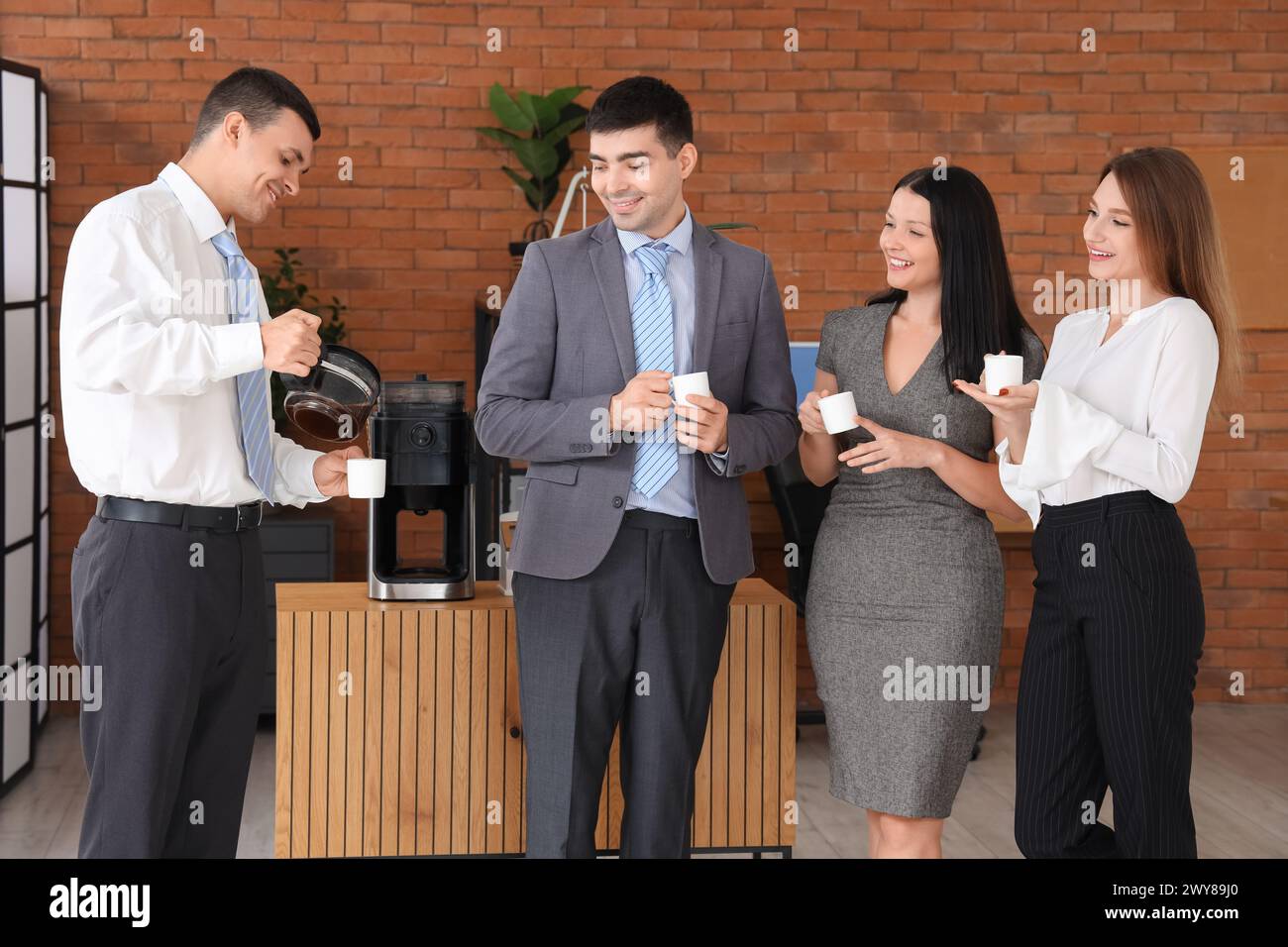Business colleagues having coffee break in office Stock Photo - Alamy