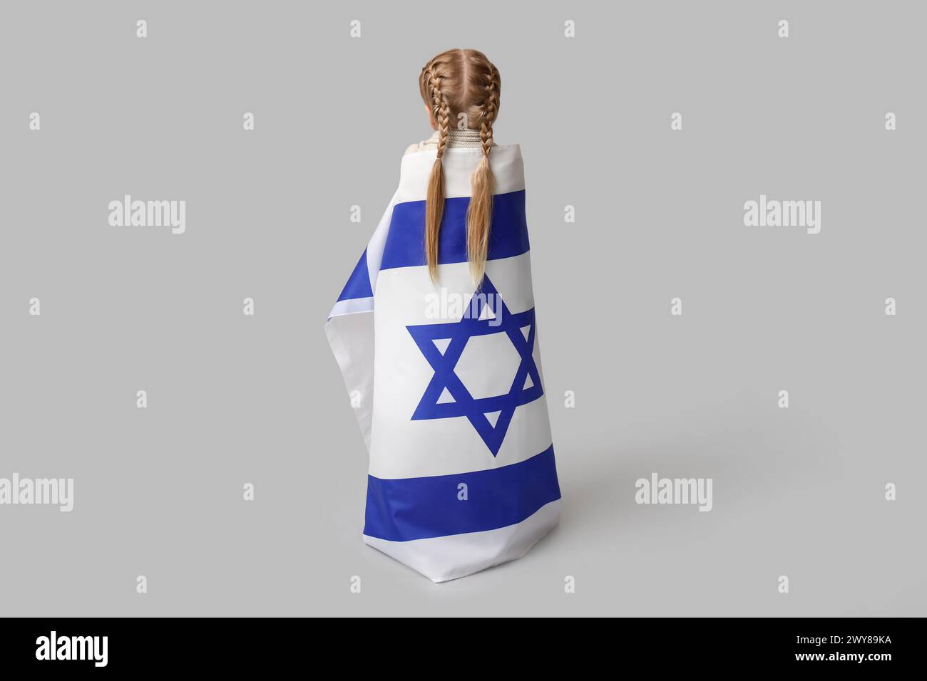 Cute little girl with Israel flag on grey background, back view ...