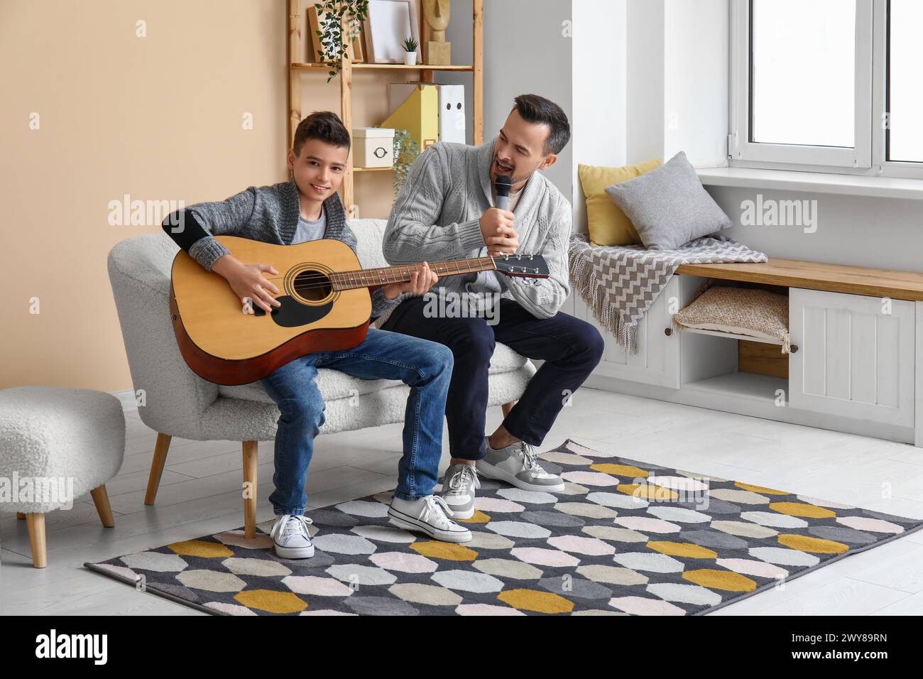 Father with his little son playing guitar and singing at home Stock ...