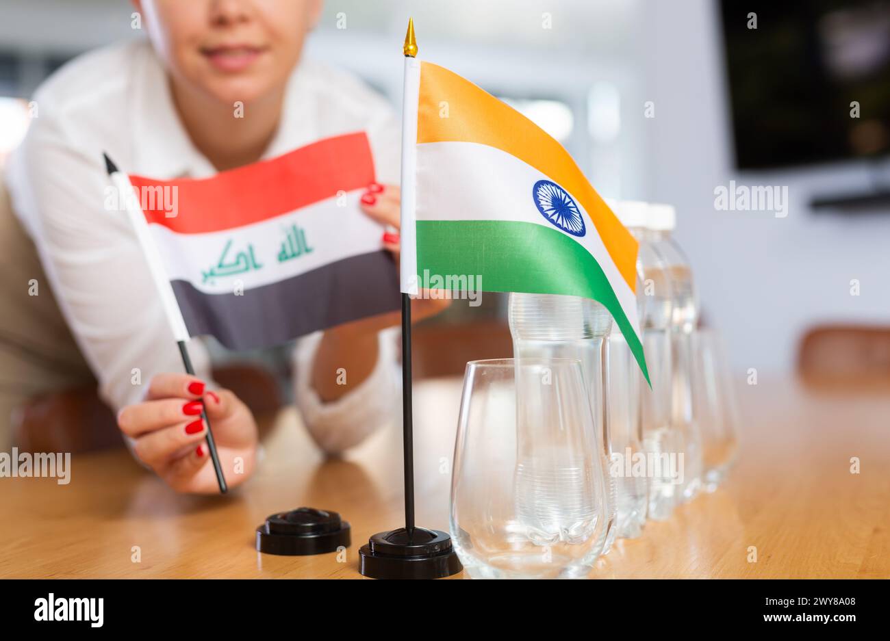 Unrecognizable girl sets midget flags of India and Iraq before ...