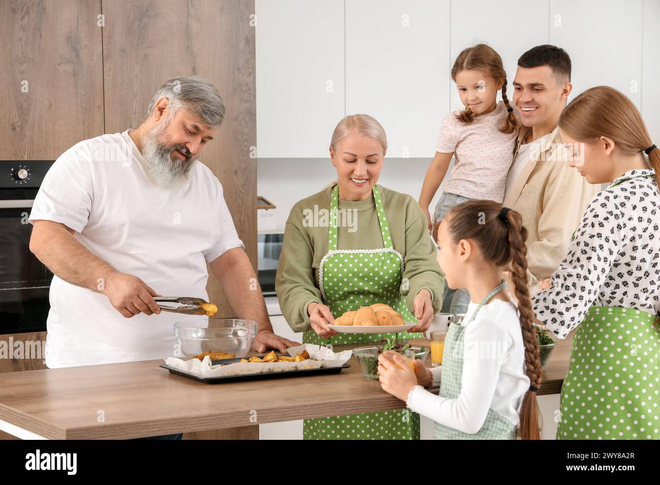 Big family cooking in kitchen Stock Photo - Alamy