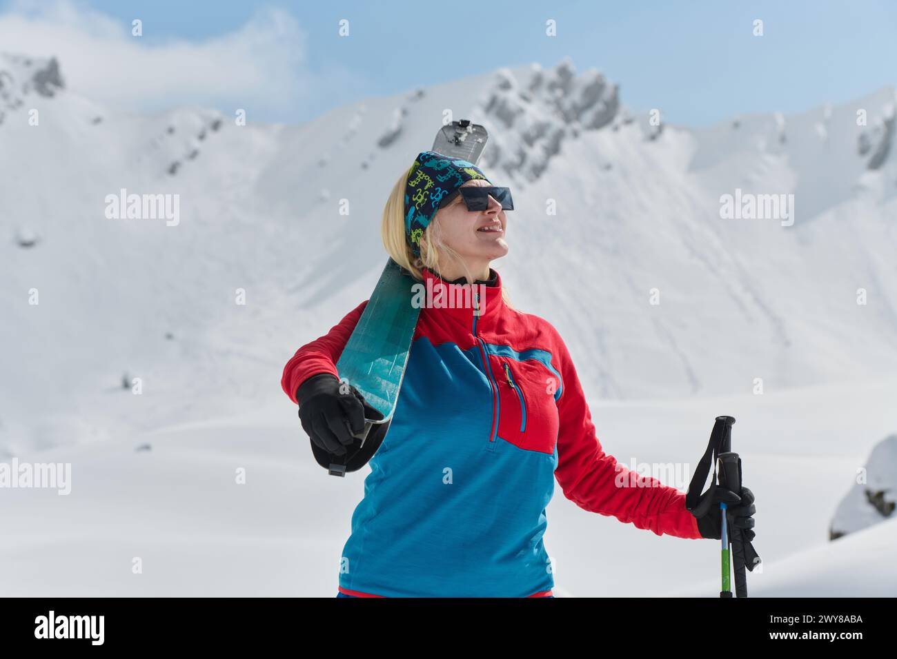 A professional woman skier rejoices after successfully climbing the ...