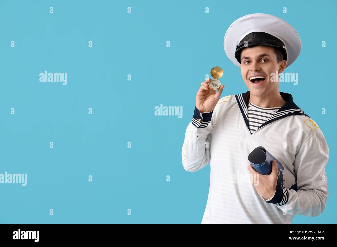 Young sailor with compass and world map on blue background Stock Photo ...