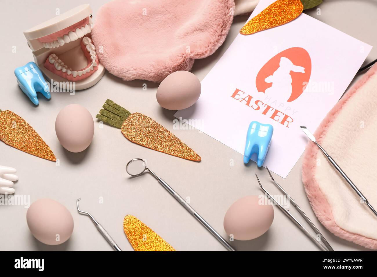 Composition with greeting card, dental tools, jaw model and Easter ...