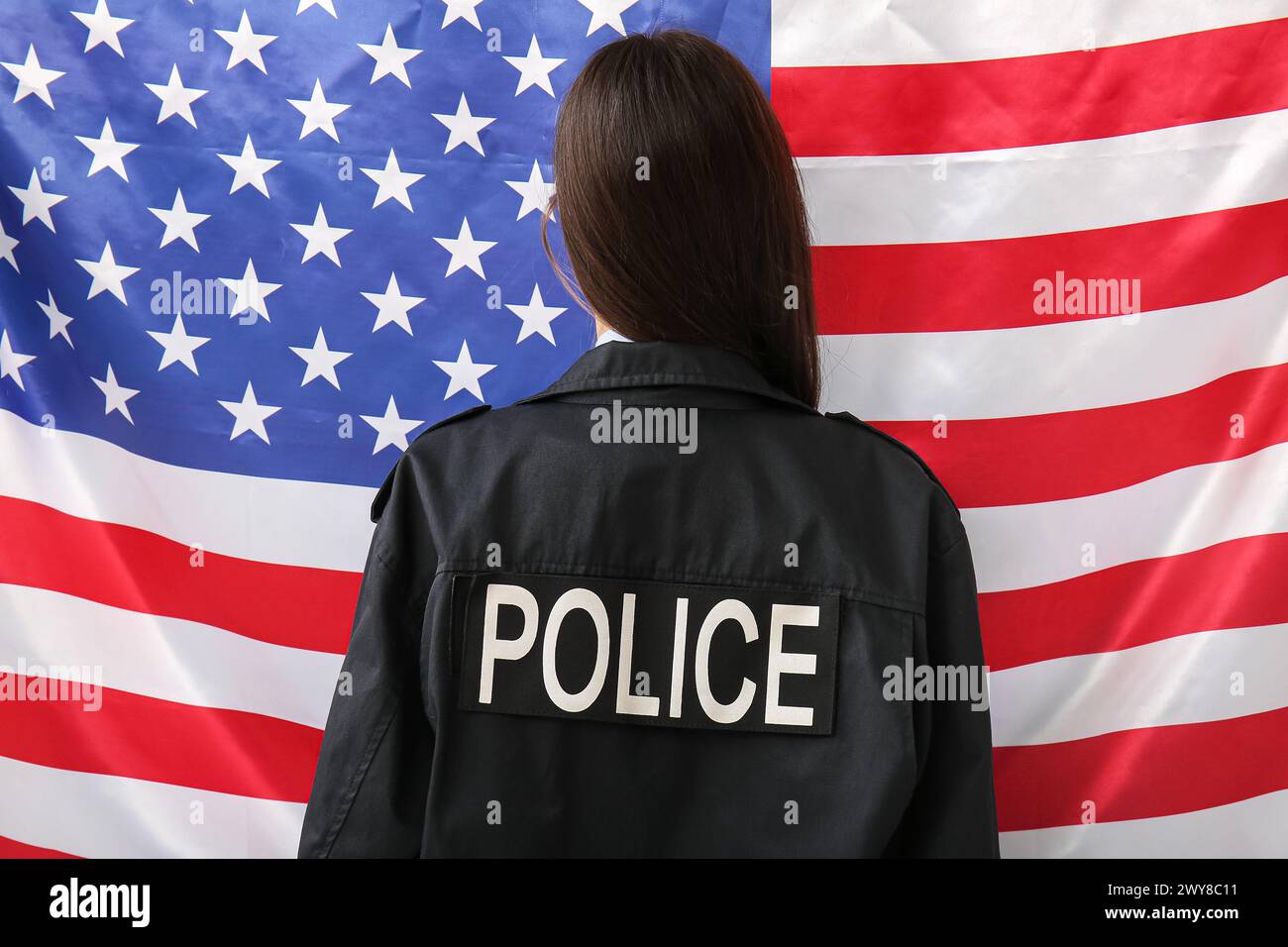 Female police officer against USA flag background, back view Stock ...