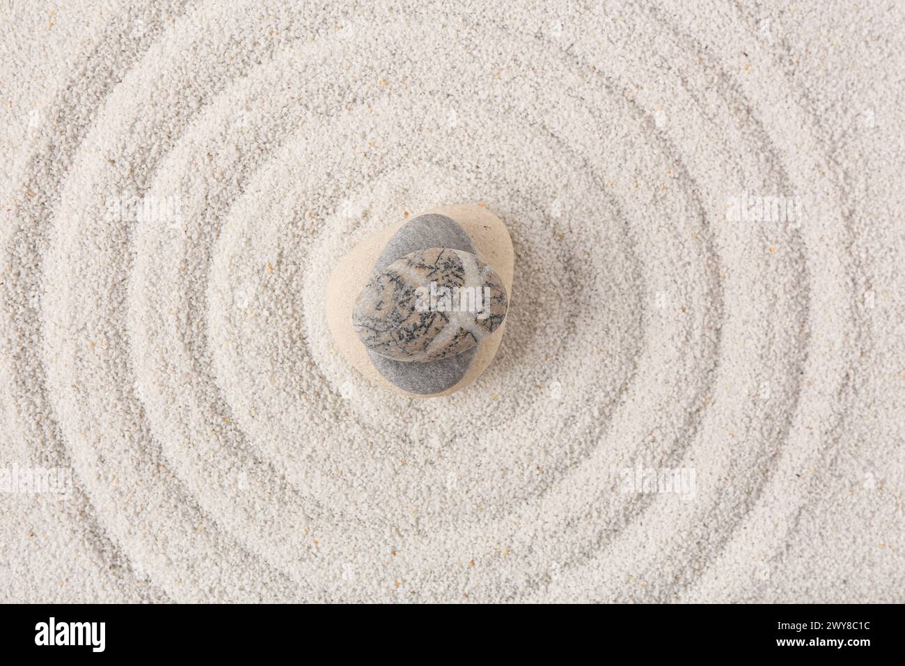 Stack of stones on sand with lines in Japanese rock garden, top view ...