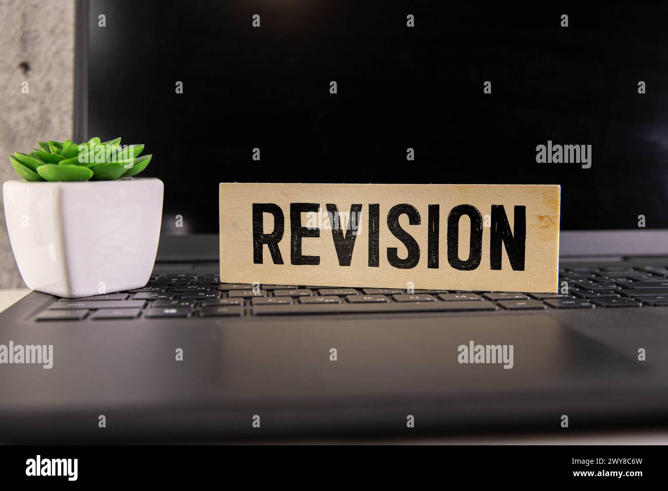 revision word made from metallic letterpress on dark jeans background ...