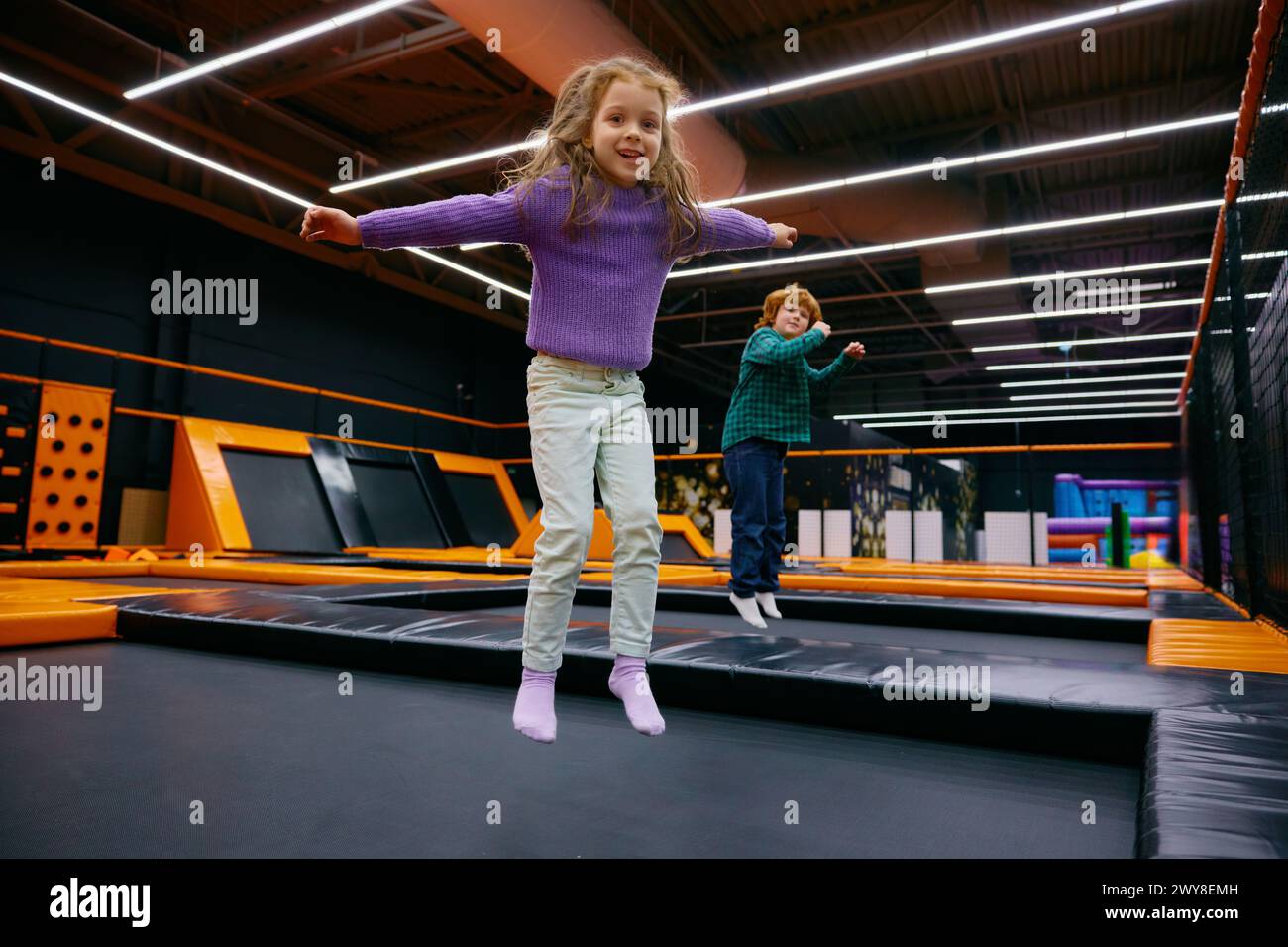 Happy children jumping on indoor playground Stock Photo - Alamy