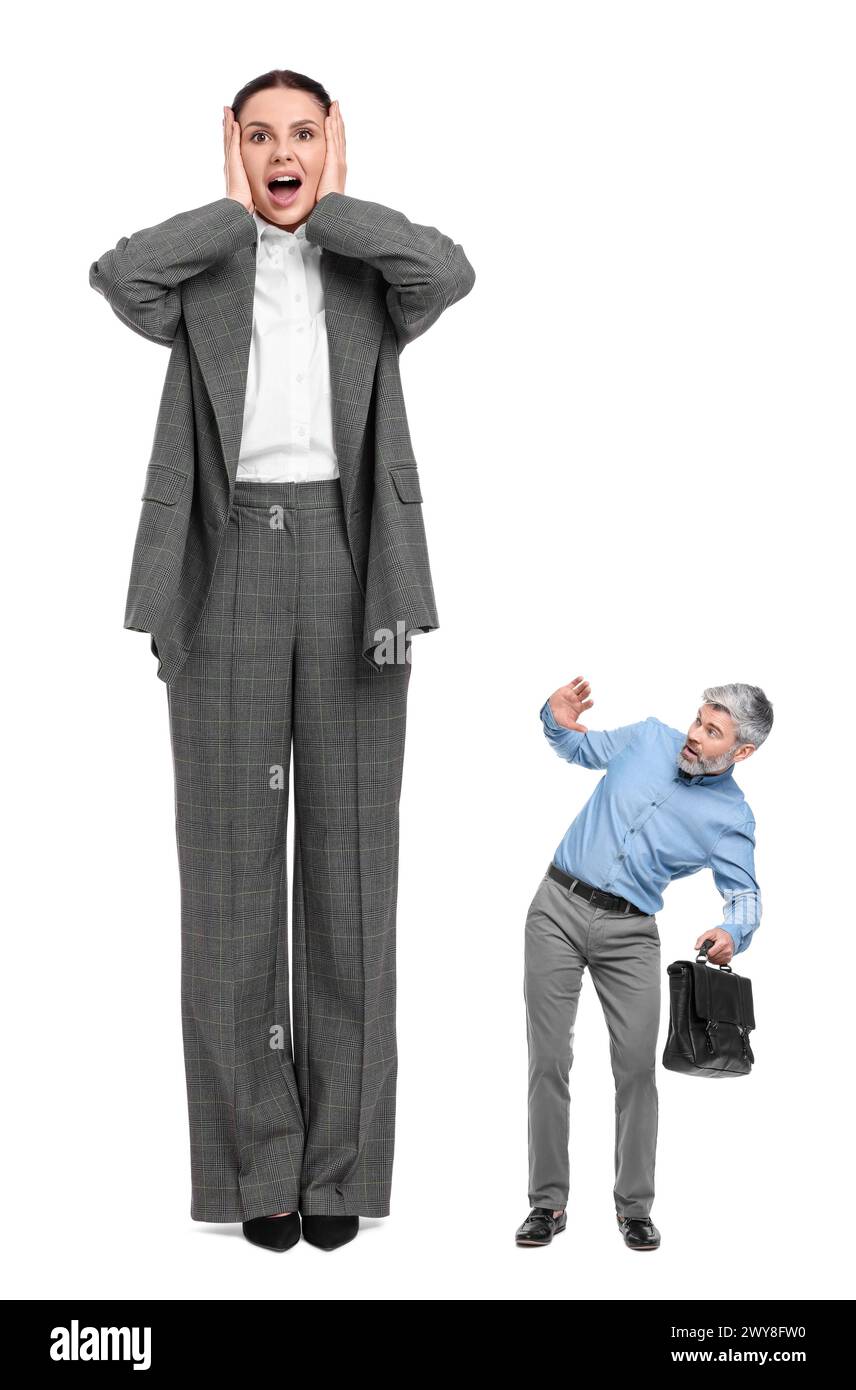 Shocked giant woman and small man on white background Stock Photo - Alamy