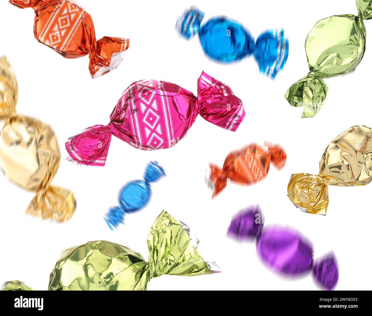 Candies in bright wrappers falling on white background Stock Photo - Alamy