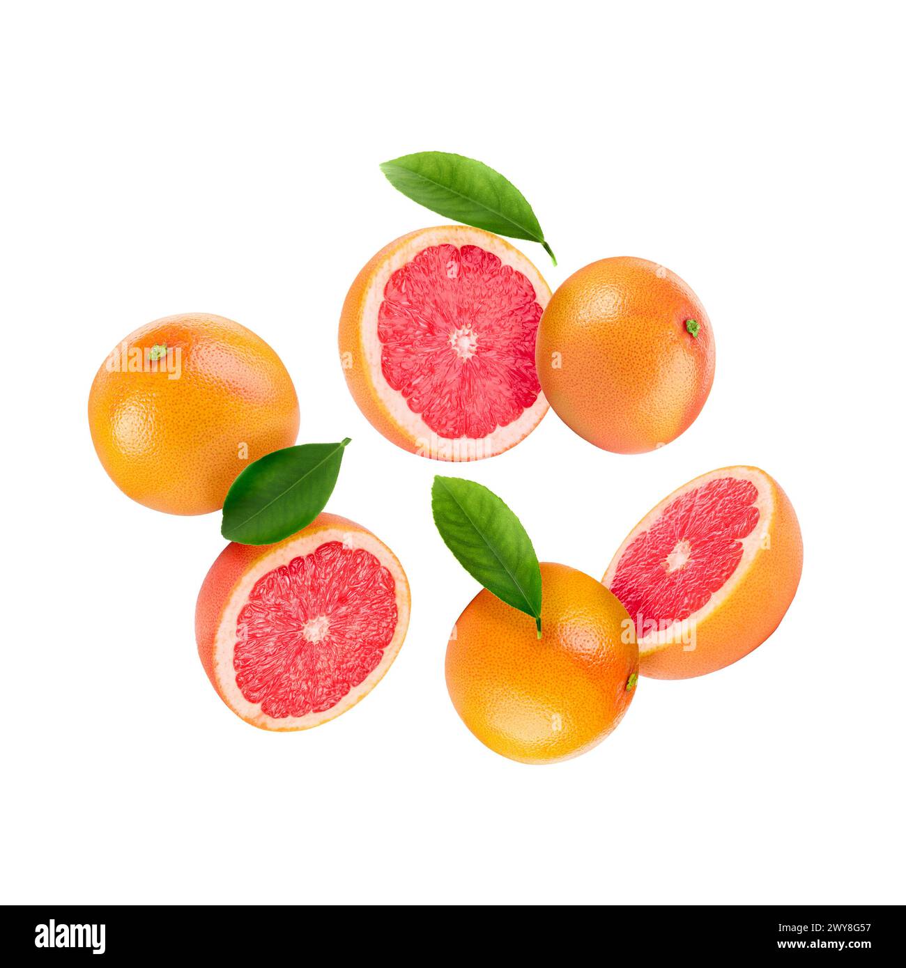 Fresh ripe grapefruits and green leaves falling on white background ...