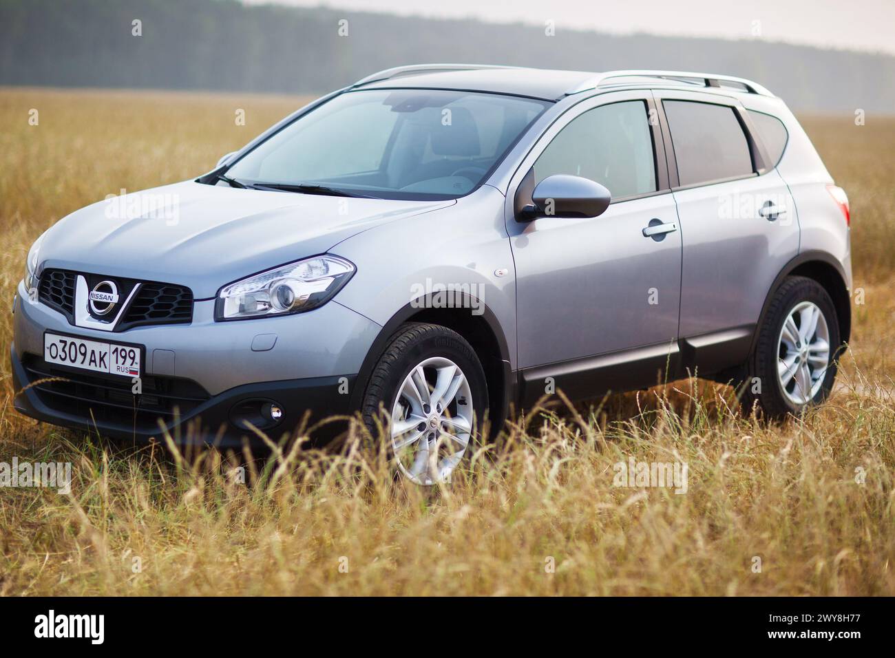 Four-wheel drive Nissan Qashqai car standing on summer field in Russia ...