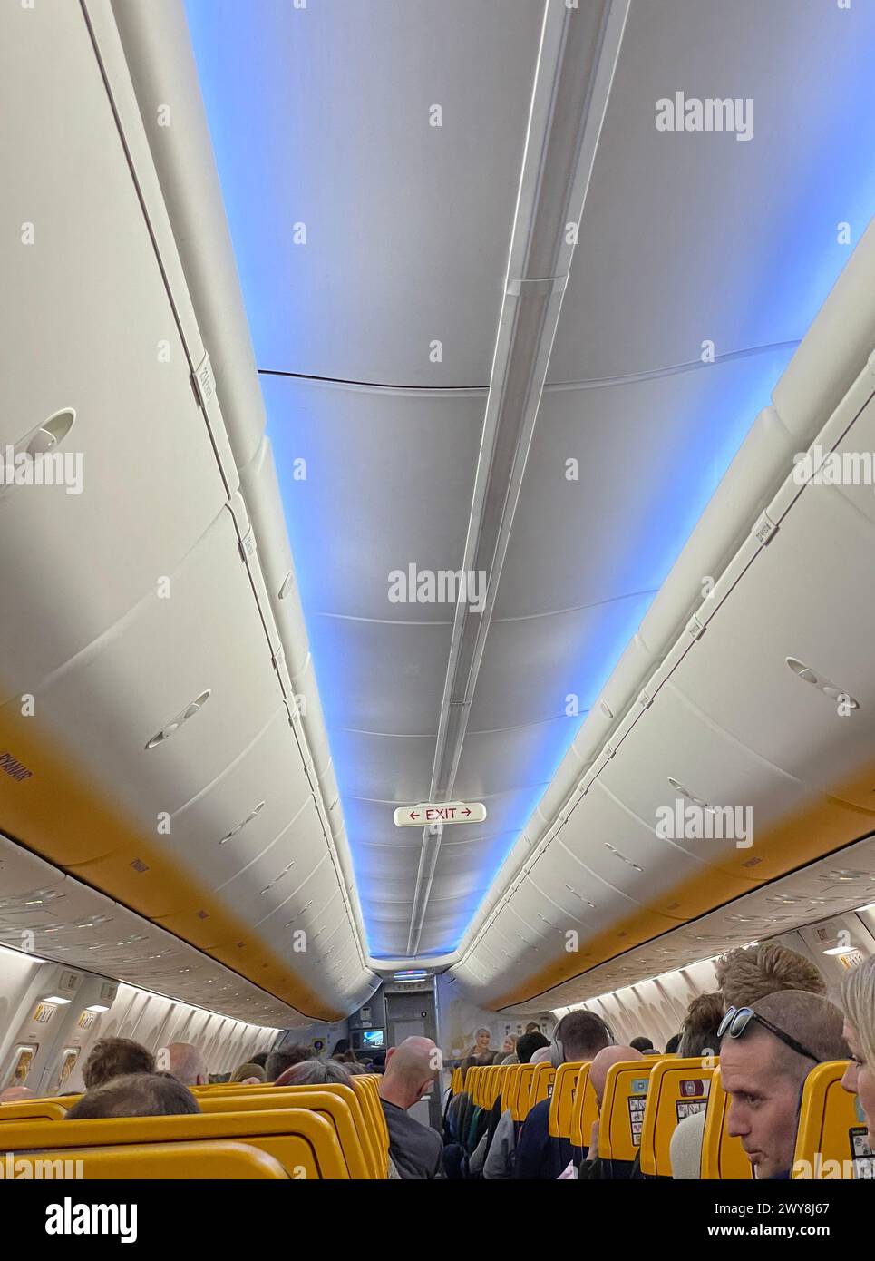 Passengers onboard a Ryan Airlines flight with Exit sign Stock Photo ...