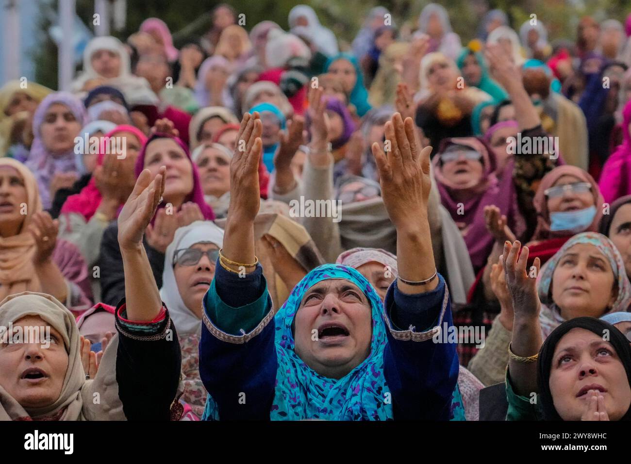 Muslim devotees pray as the head priest displays a holy relic believed ...
