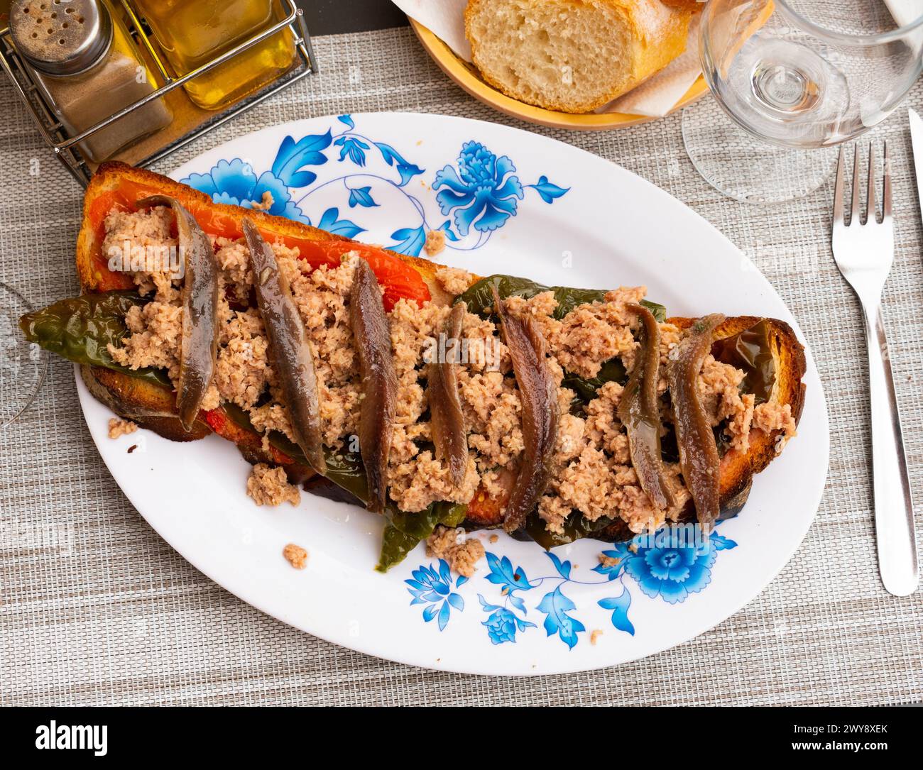 Traditional Spanish toasted bread with tuna, anchovy and baked pepper ...