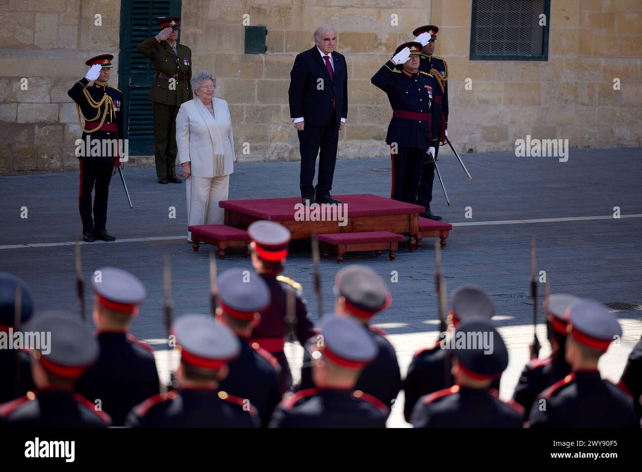 Outgoing Malta President George Abela 3rd R stands on a dais flanked by ...