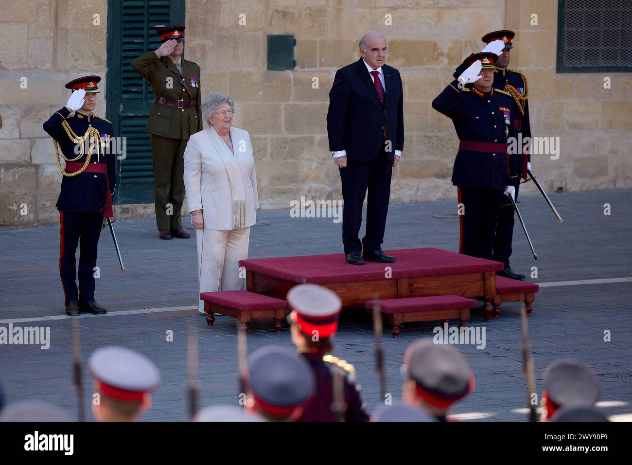 Outgoing Malta President George Abela 3rd R stands on a dais flanked by ...