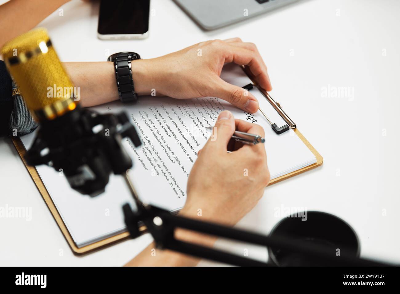 Selective focusing on hands with writing script note of radio ...