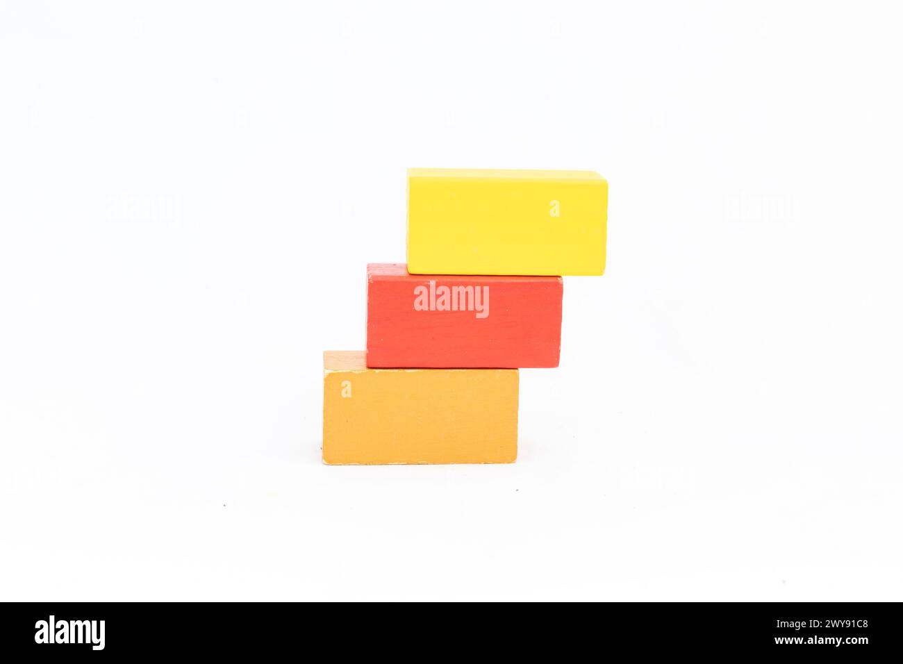 Colored wooden rectangular blocks on a white background. Blank yellow ...