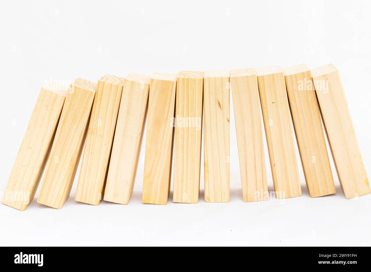 Wooden blocks standing supporting each other on white background ...
