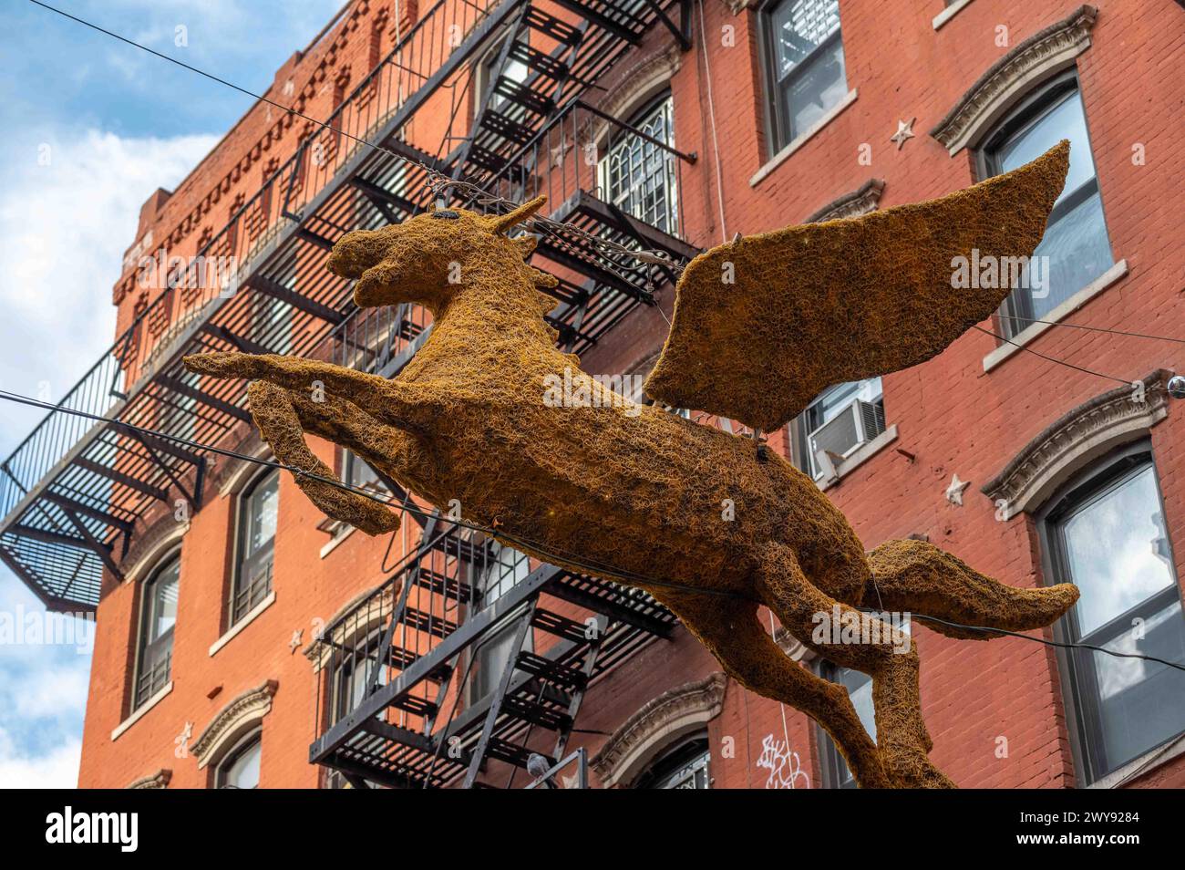 Flying horse decoration over Chinatown NY street fire escapes Stock ...