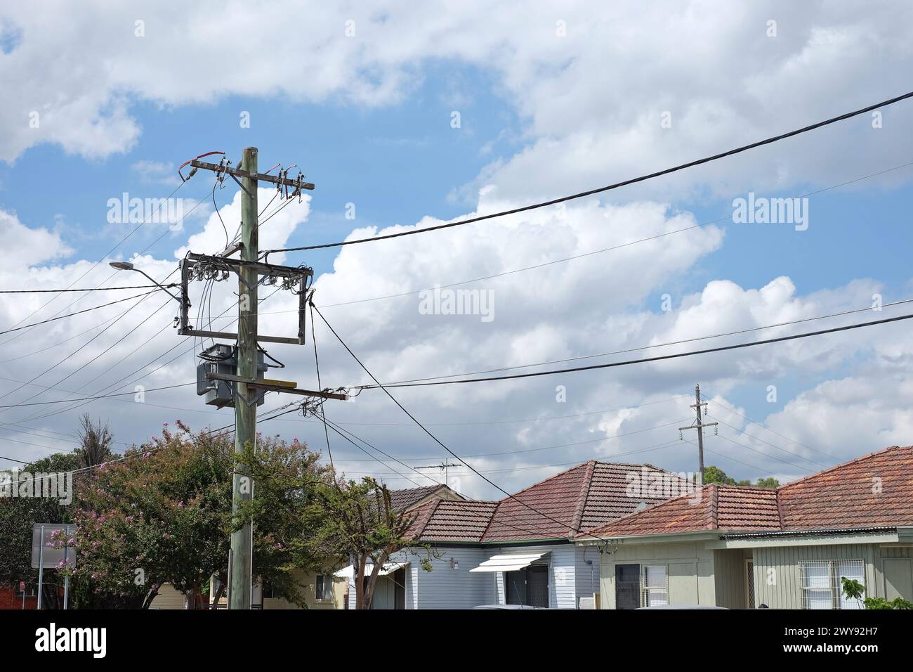 Power transmission lines and power pole with transformer, clouds and ...