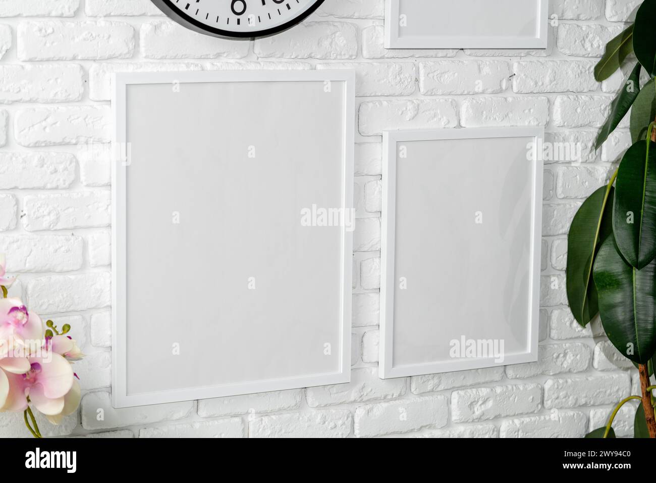 Minimalist White Wall Display With Clock and Empty Frames in a Modern ...