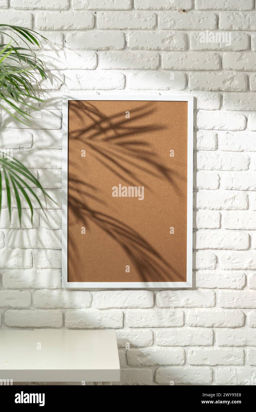 Shadow of Palm Leaves Cast on Framed Picture Against White Brick Wall ...