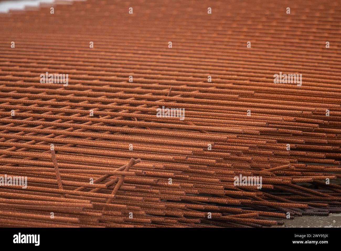 Pile of rusty rebar on concrete floor Stock Photo - Alamy