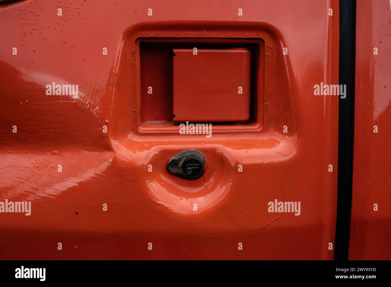 Latch of the engine cover of an orange excavator Stock Photo - Alamy